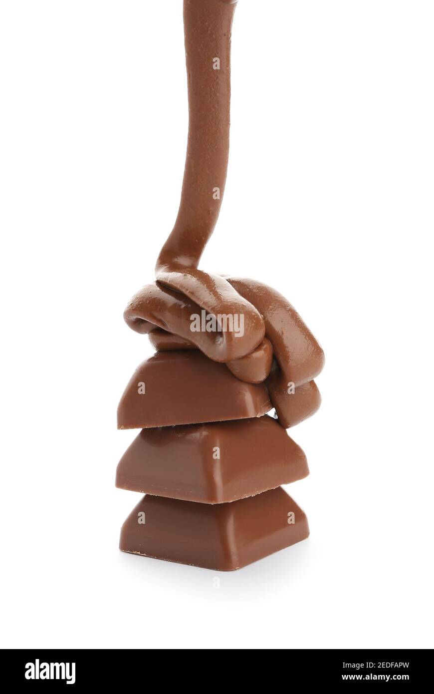 Pouring of melted chocolate on candies against white background Stock ...