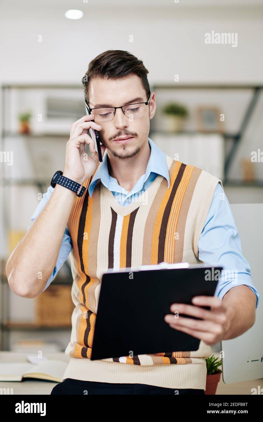 Serious businessman making phone call Stock Photo - Alamy