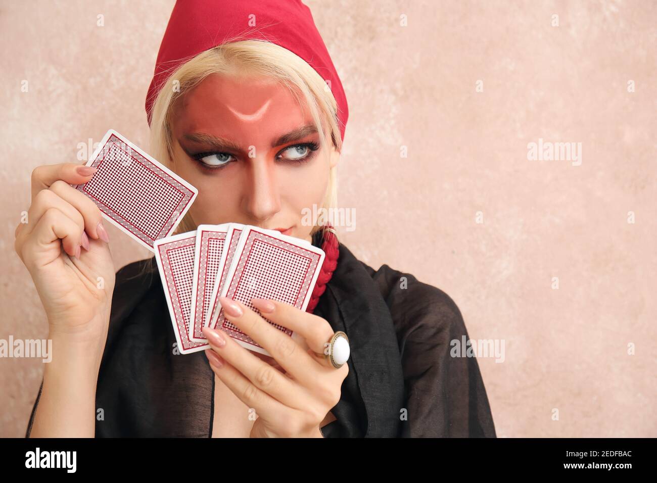 Fortune teller with cards on color background Stock Photo - Alamy