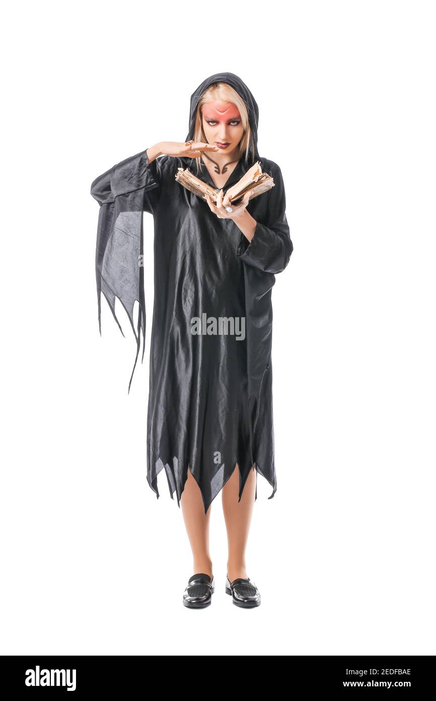 Scary young witch with spell book on white background Stock Photo - Alamy