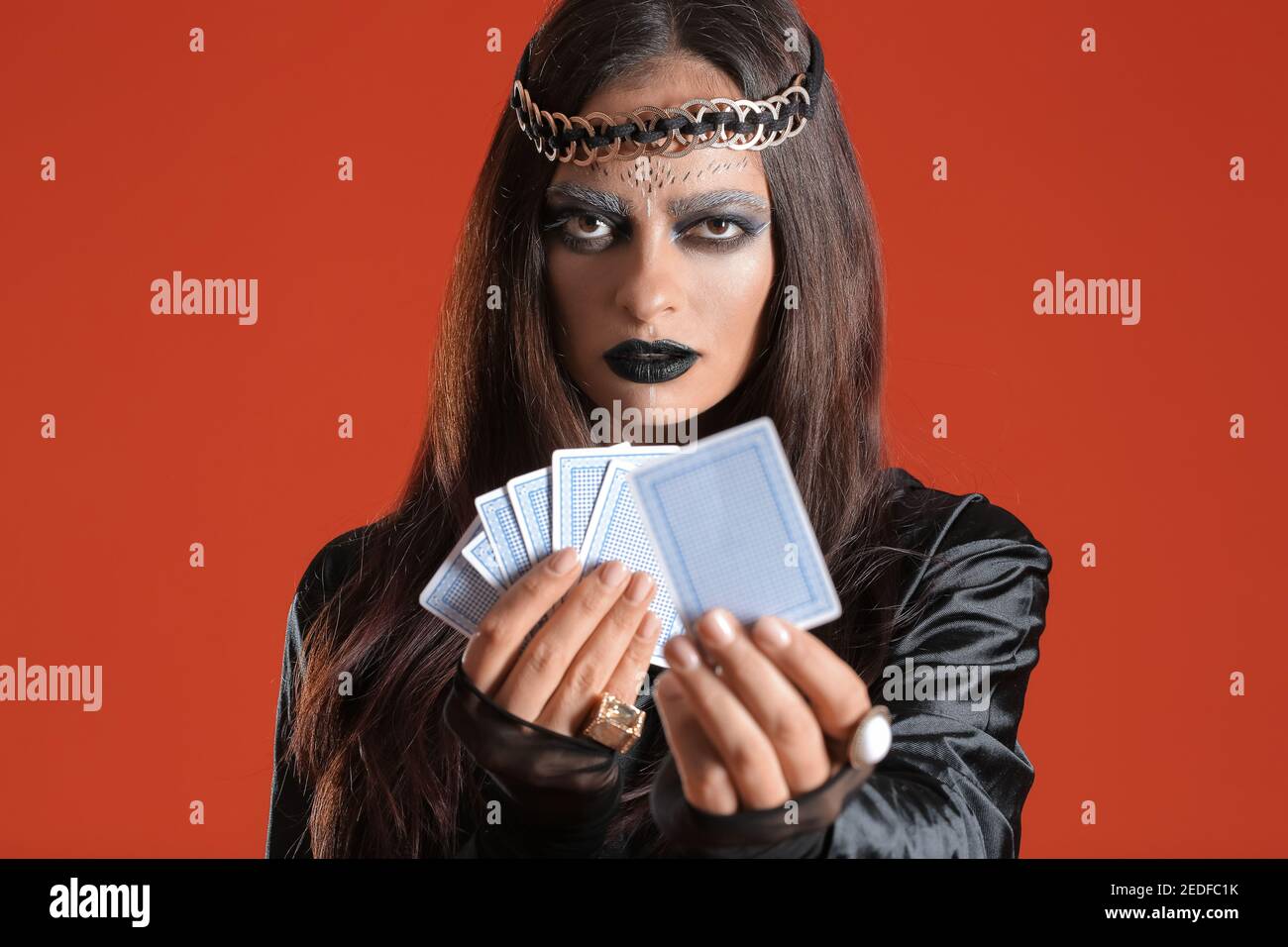 Fortune teller with cards on color background Stock Photo - Alamy
