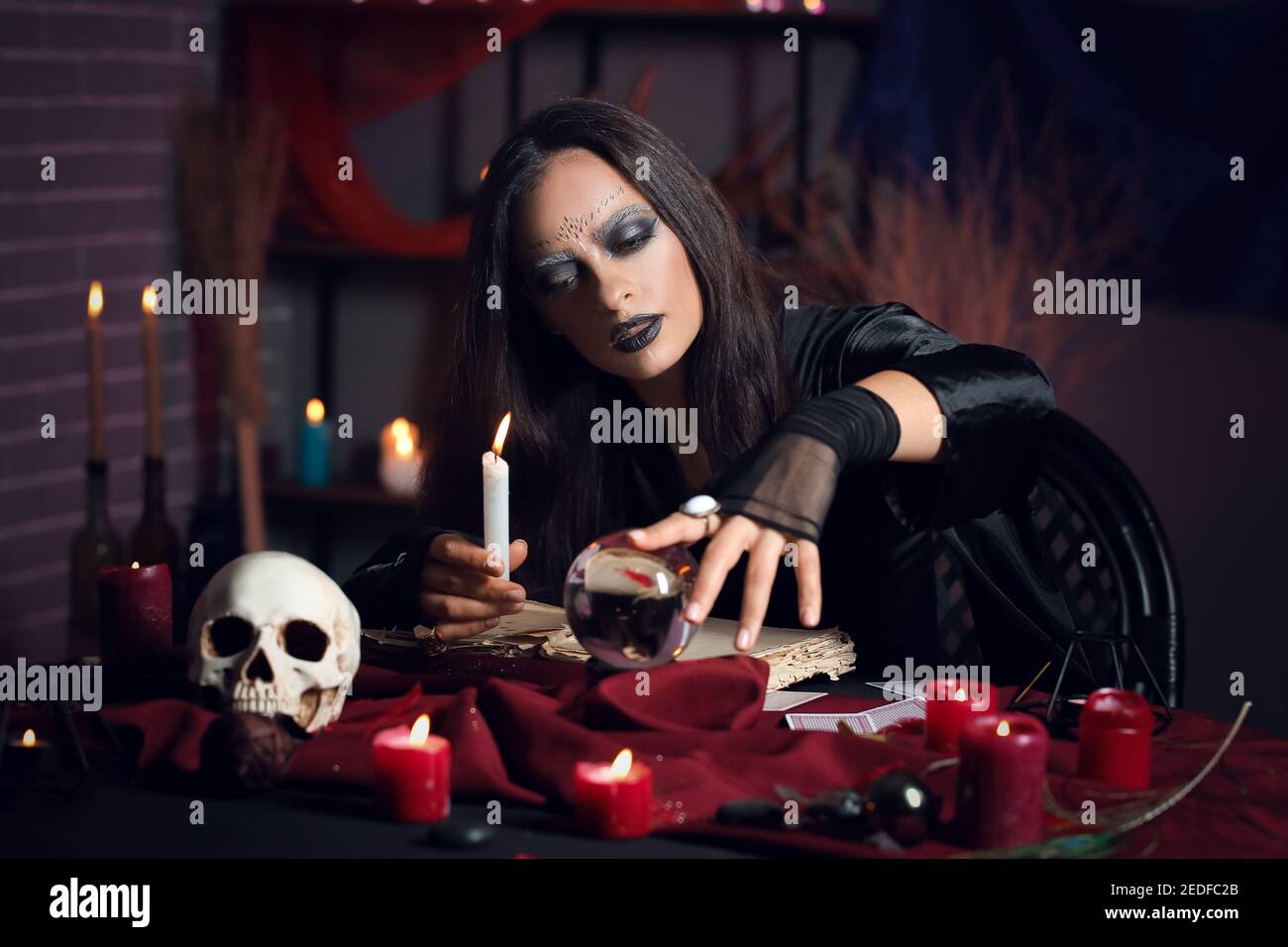 Witch performing black magic ritual Stock Photo - Alamy