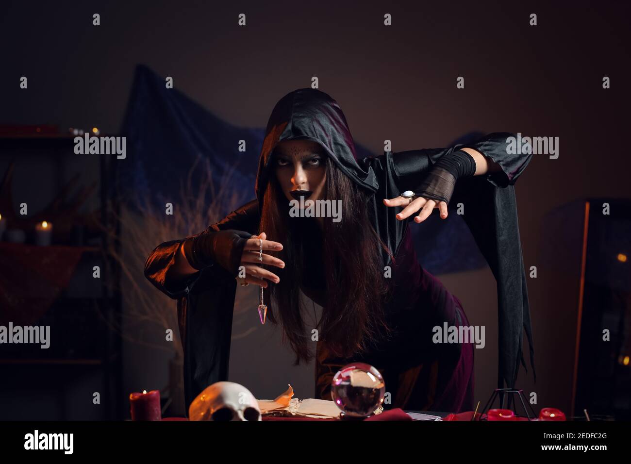 Witch performing black magic ritual Stock Photo - Alamy