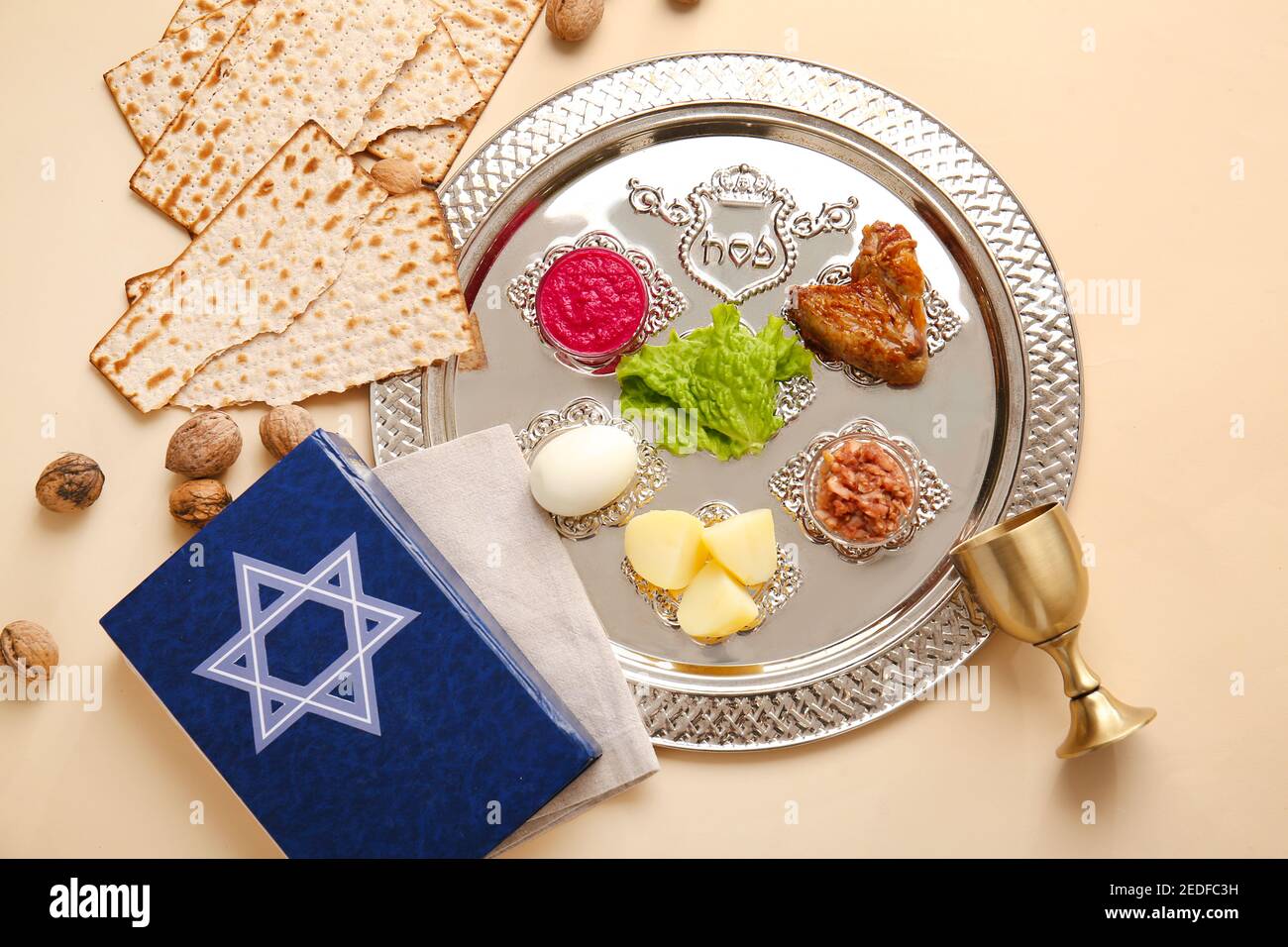 Passover Seder plate with traditional food and Torah on color ...
