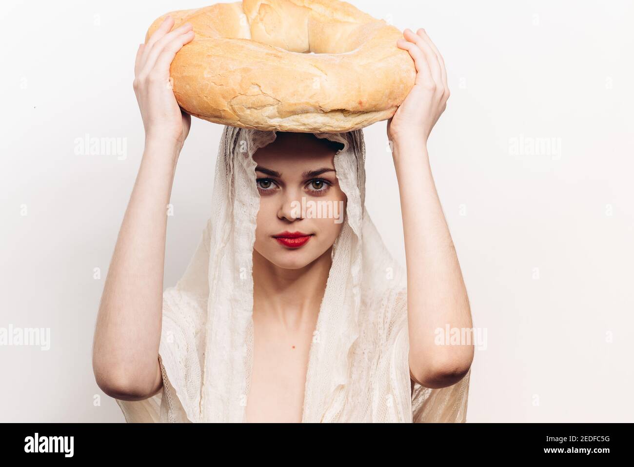 happy woman with cloth on her head and loaf of bread flour product in ...