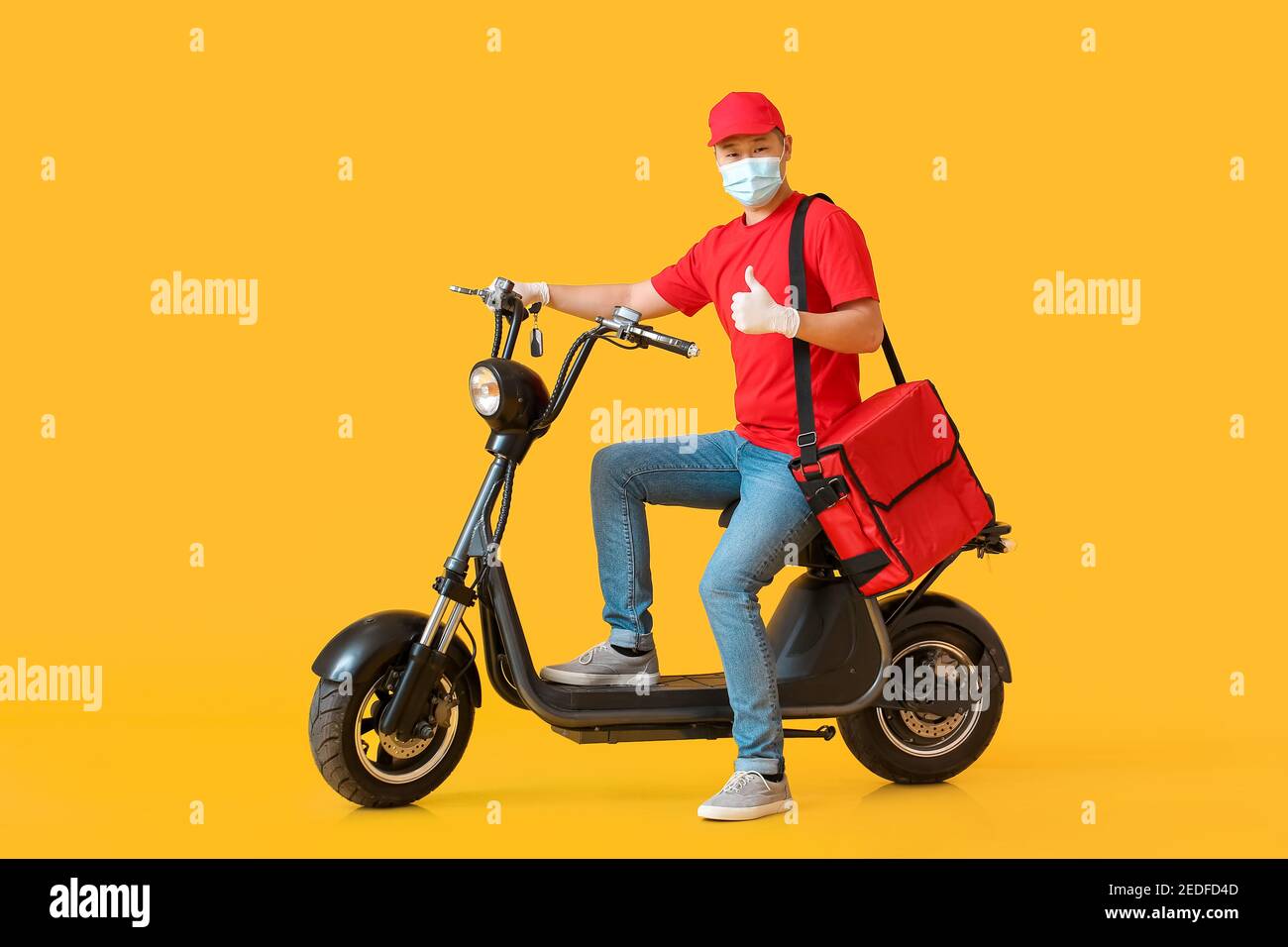 Courier of food delivery service showing thumb-up on color background ...