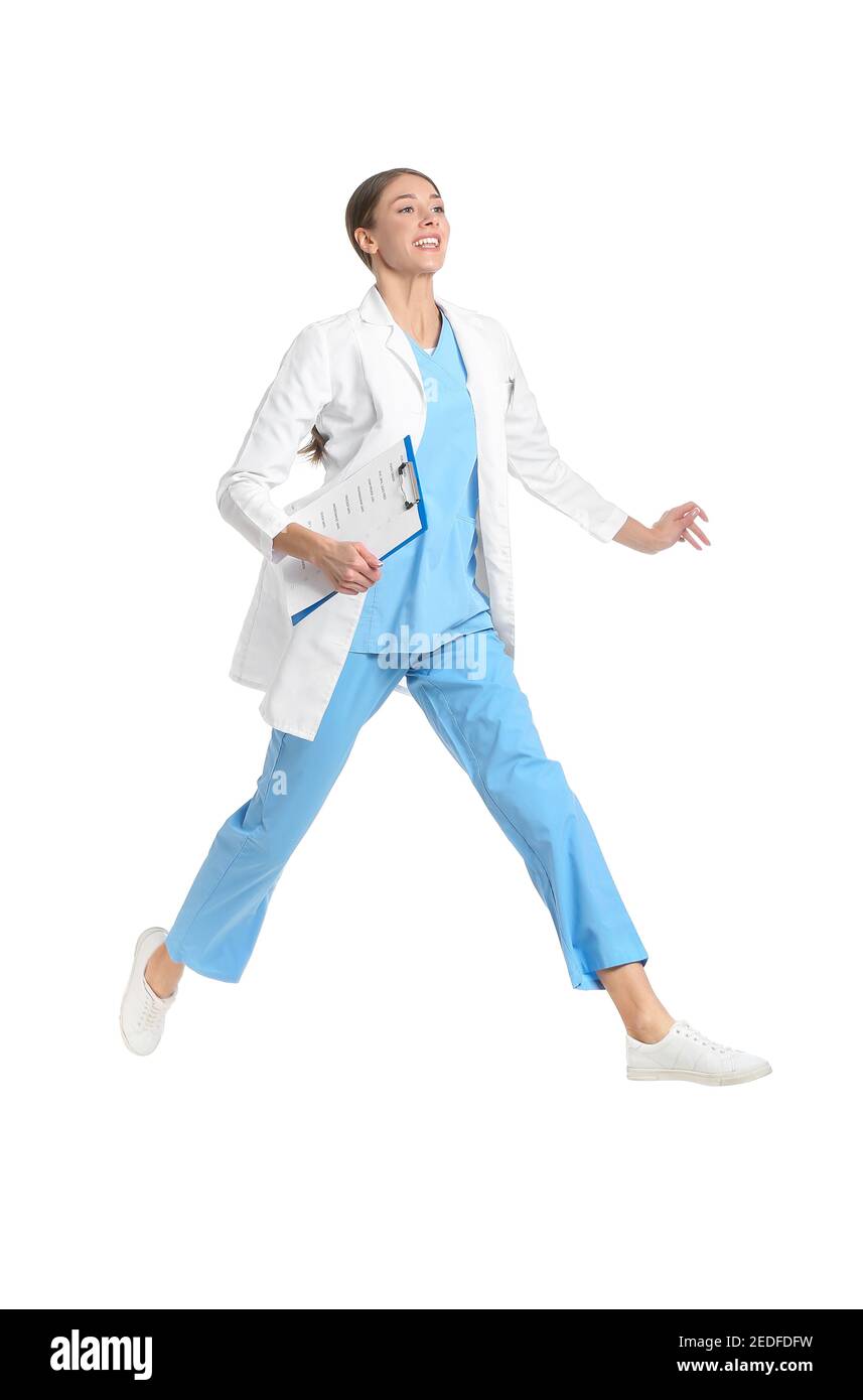 Jumping female doctor against white background Stock Photo - Alamy
