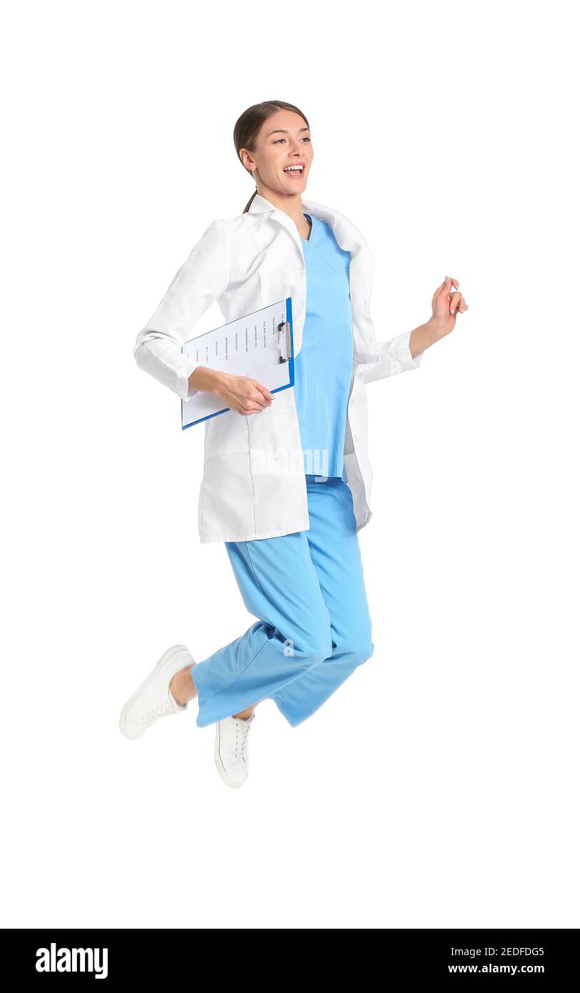 Jumping female doctor against white background Stock Photo - Alamy