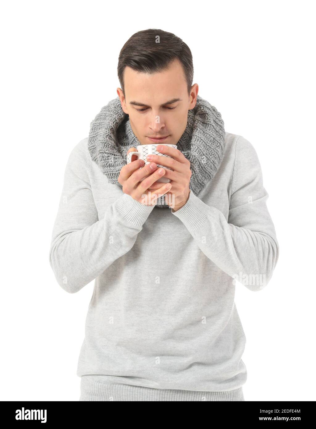 Sick man with hot tea on white background Stock Photo - Alamy