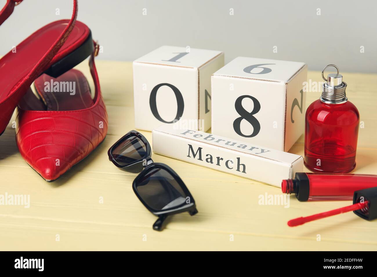 Calendar, cosmetics and accessories on table. International Women's Day ...
