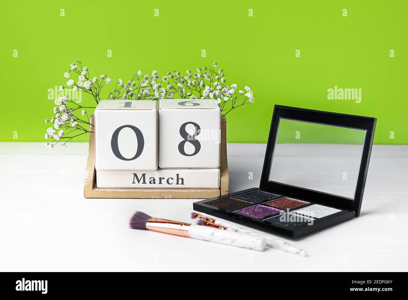 Calendar with makeup cosmetics on table. International Women's Day ...