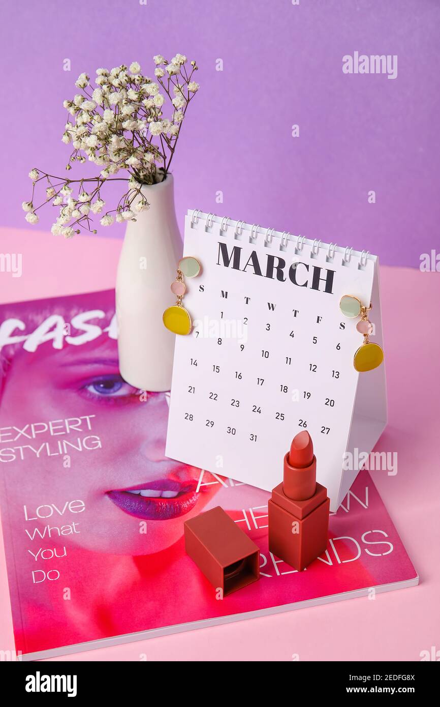 Calendar with female accessories, flowers and fashion magazine on color ...