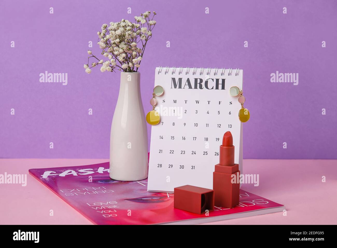 Calendar with female accessories, flowers and fashion magazine on color ...