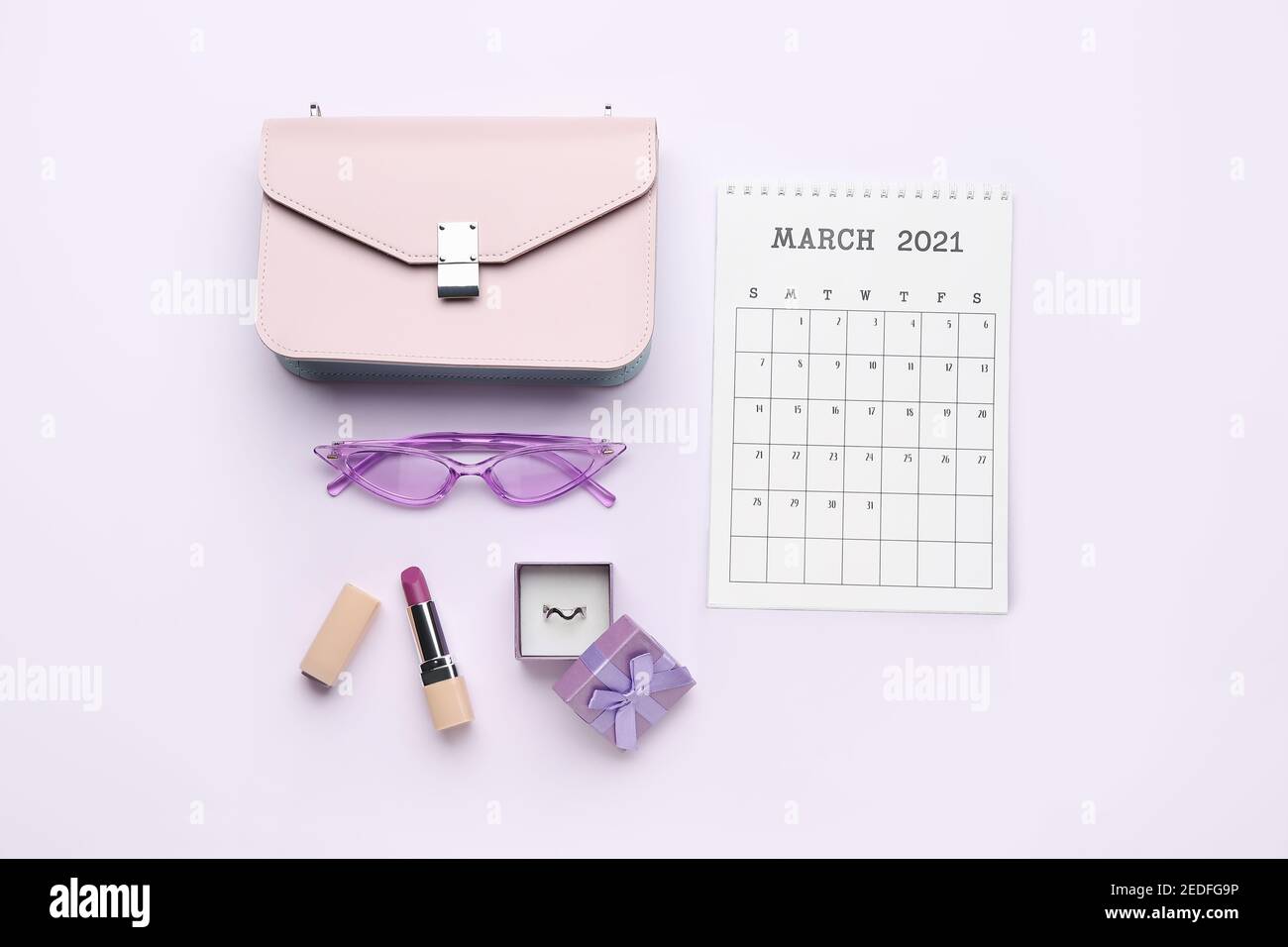 Calendar with female accessories on light background. International ...