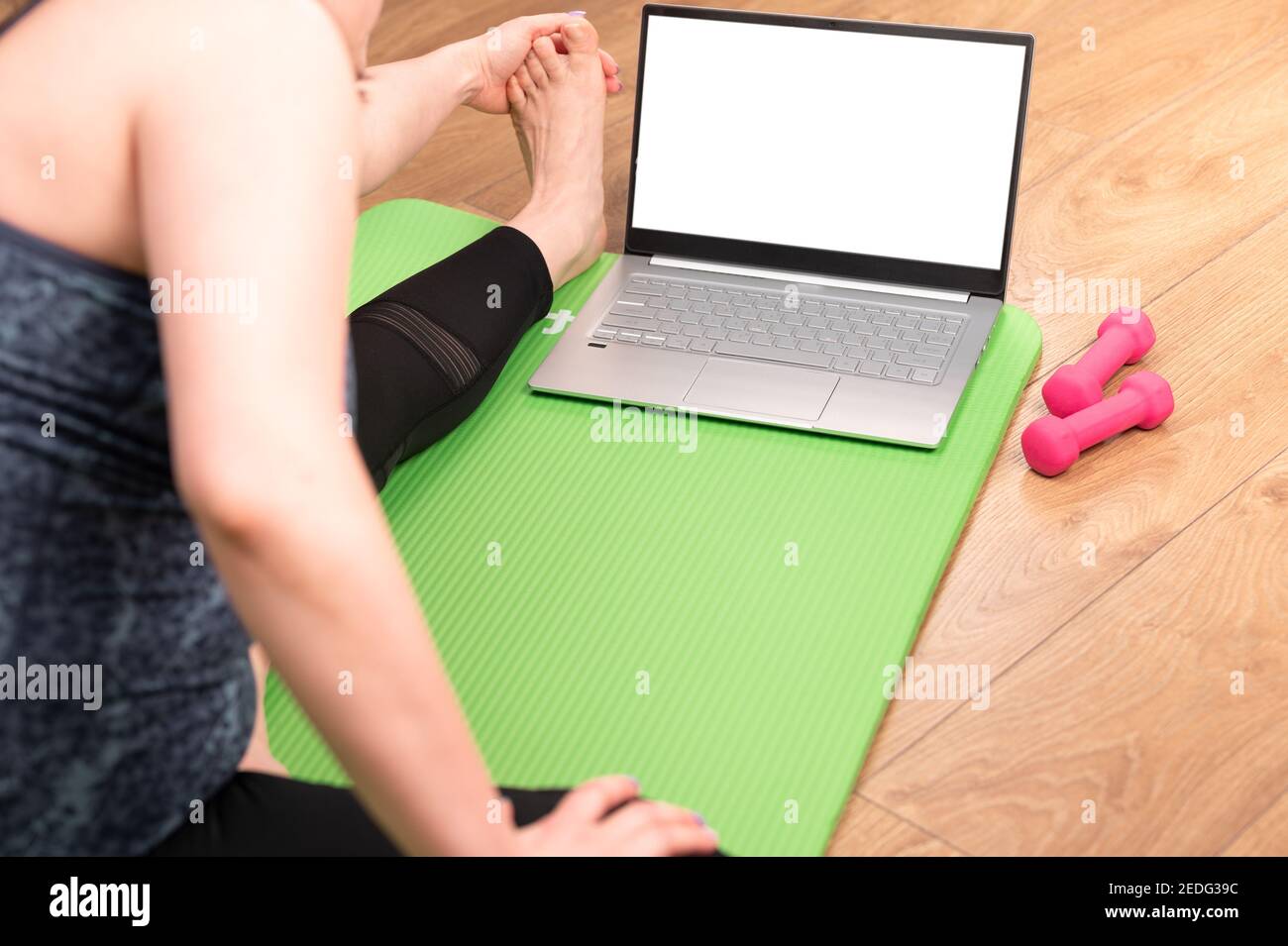 Online Laptop Yoga Home Fitness Workout. Fit woman in sportswear doing ...