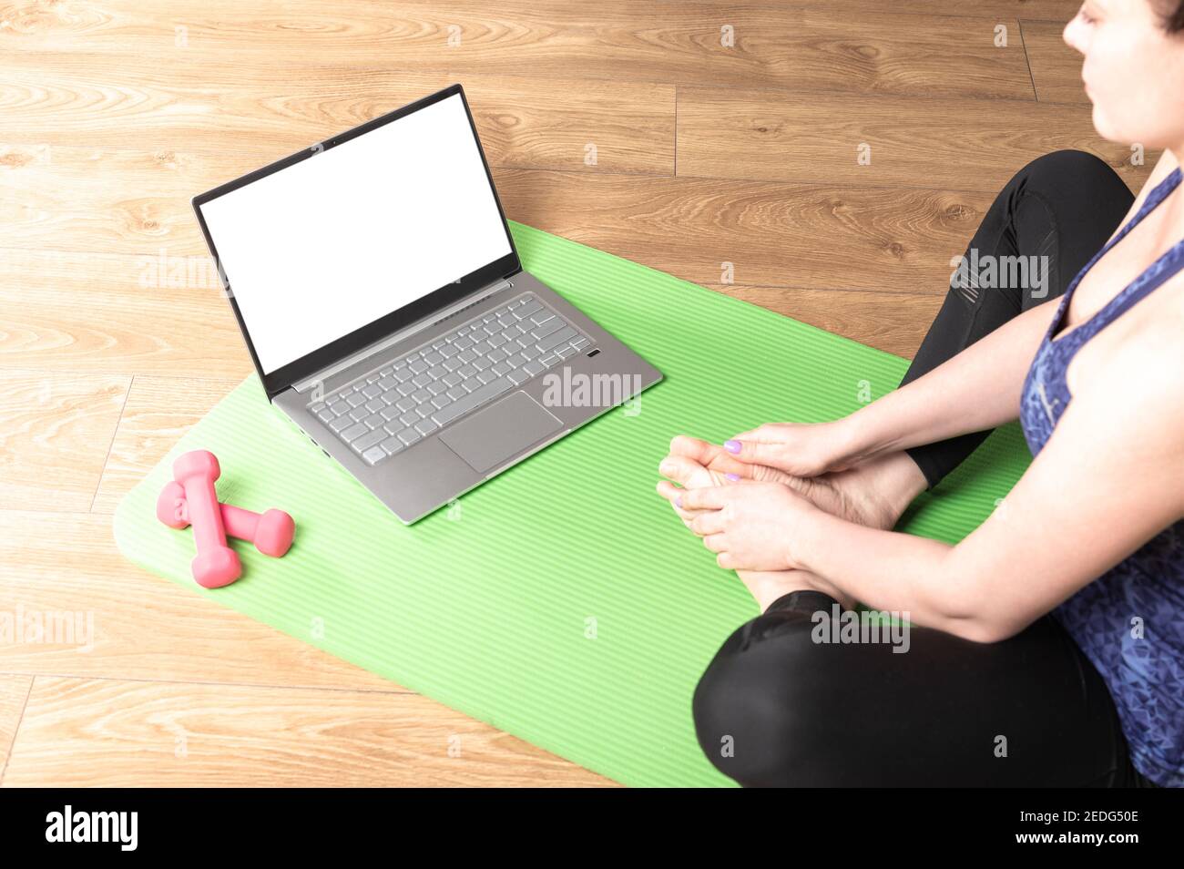 woman practicing some meditation and yoga at home in a laptop computer ...