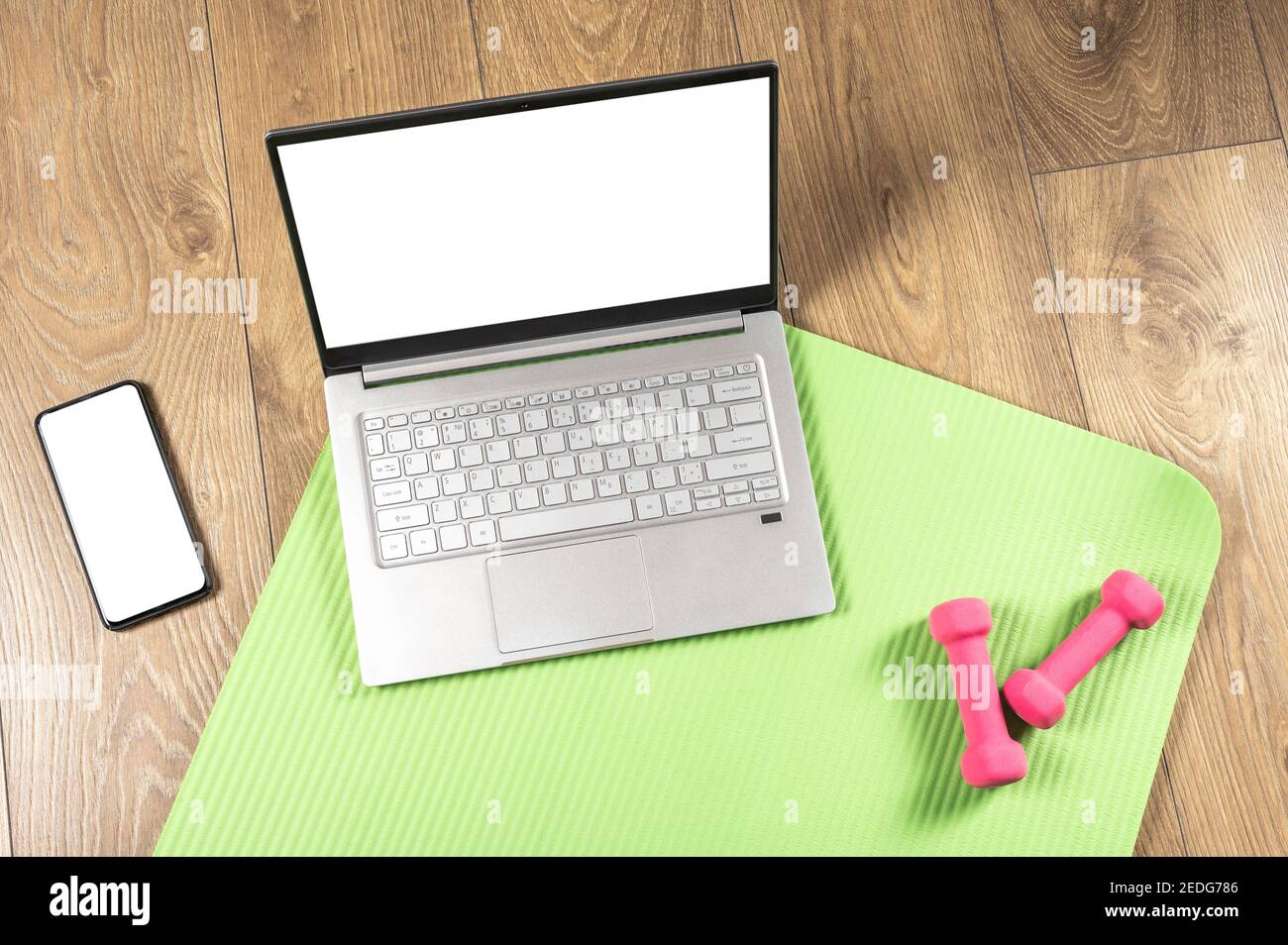 online yoga fitness, laptop mockup. Pink dumbbells, gym mat and grey ...