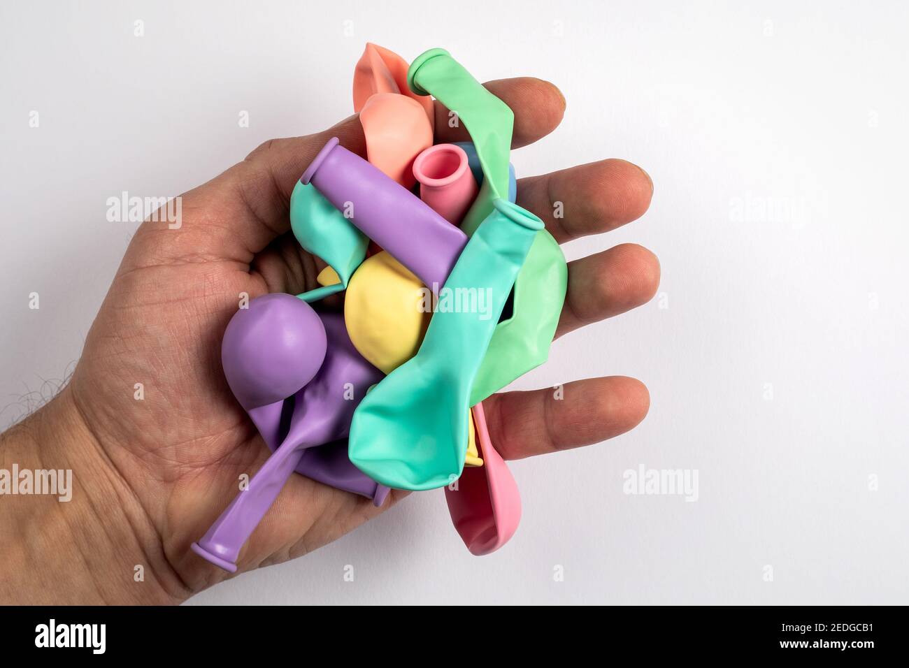 Colored balloons in a man's hand on a white background Stock Photo - Alamy