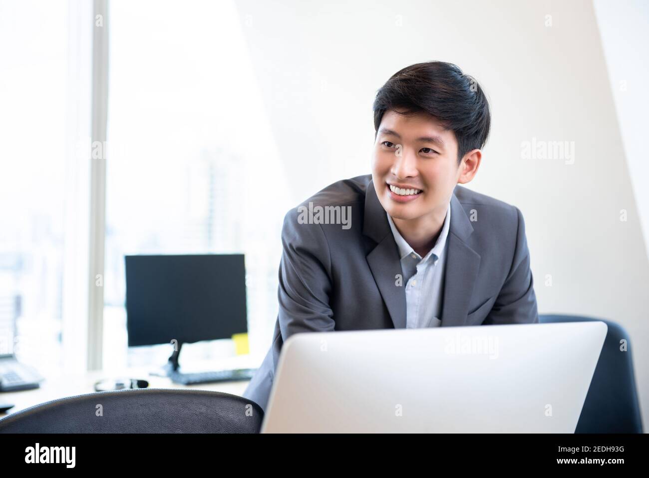 Young smiling Asian chinese businessman working in the office Stock ...