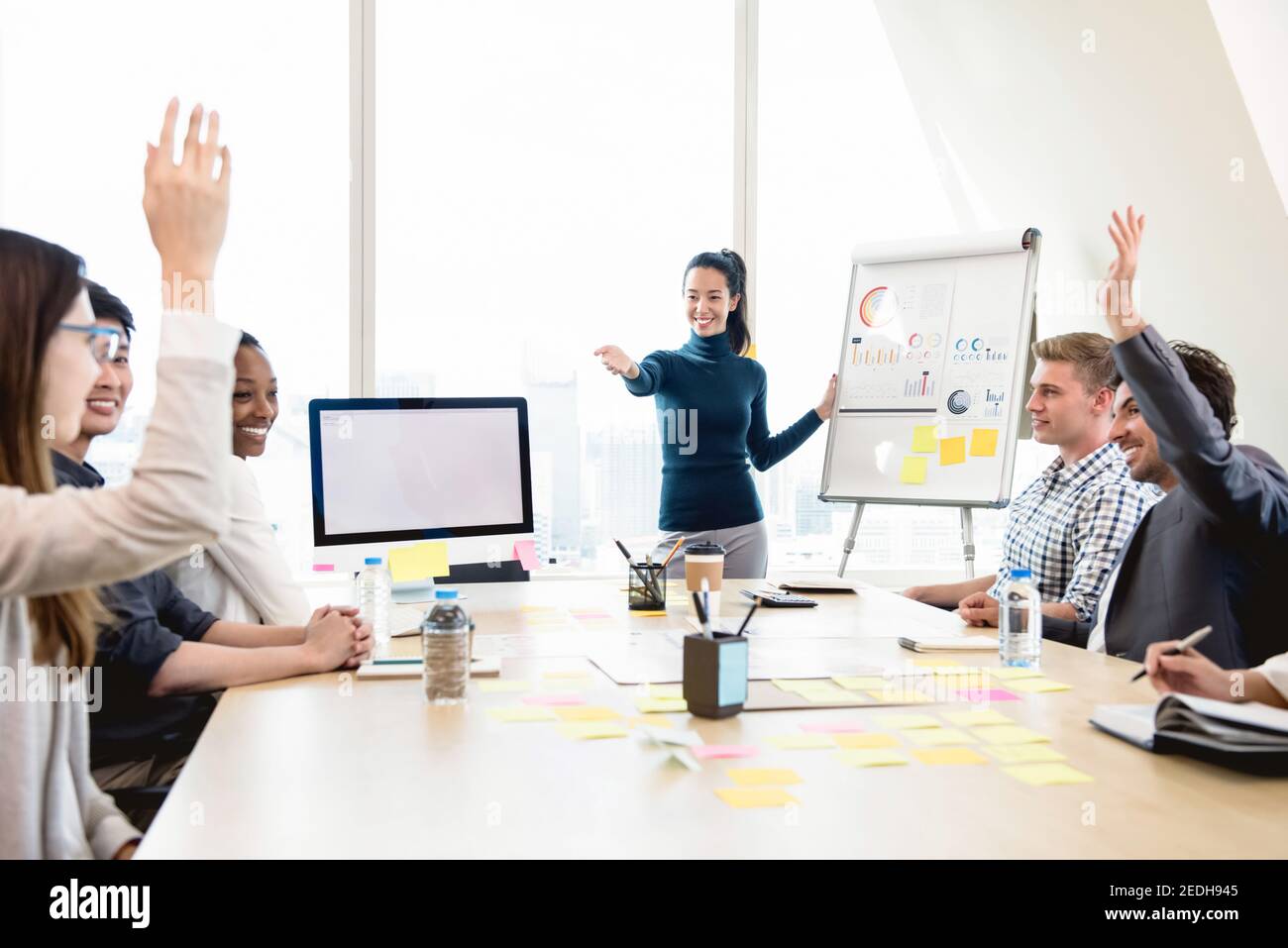 Young casual Asian businesswoman leader making a presentation and ...