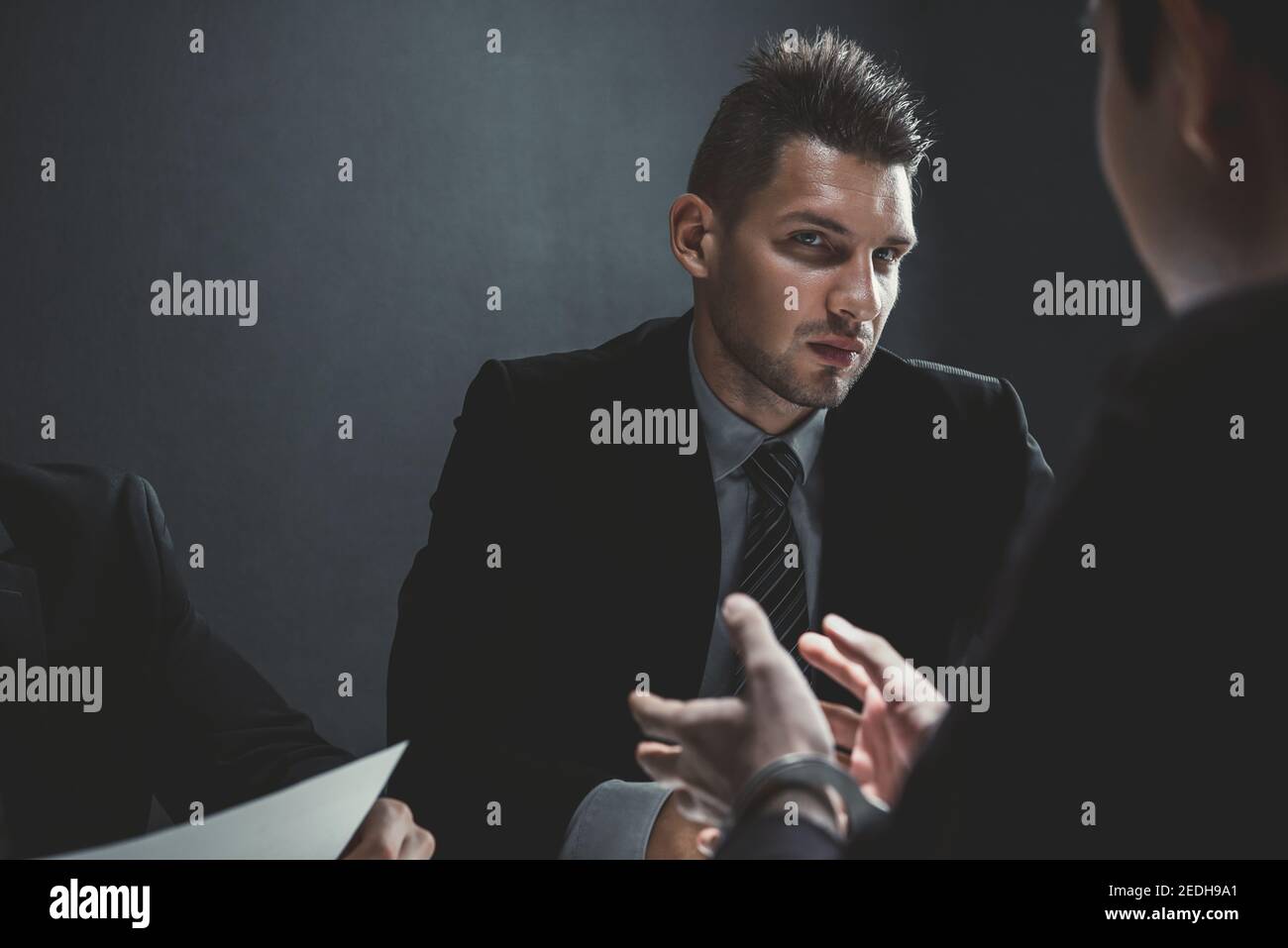 Detectives in interrogation room interviewing suspect or criminal man ...