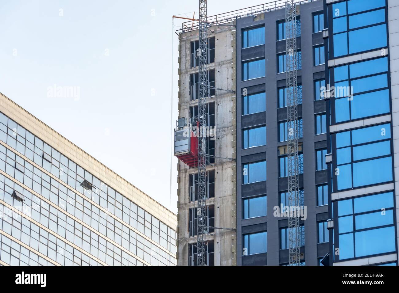Construction elevator outside the facade of a multi-storey building ...