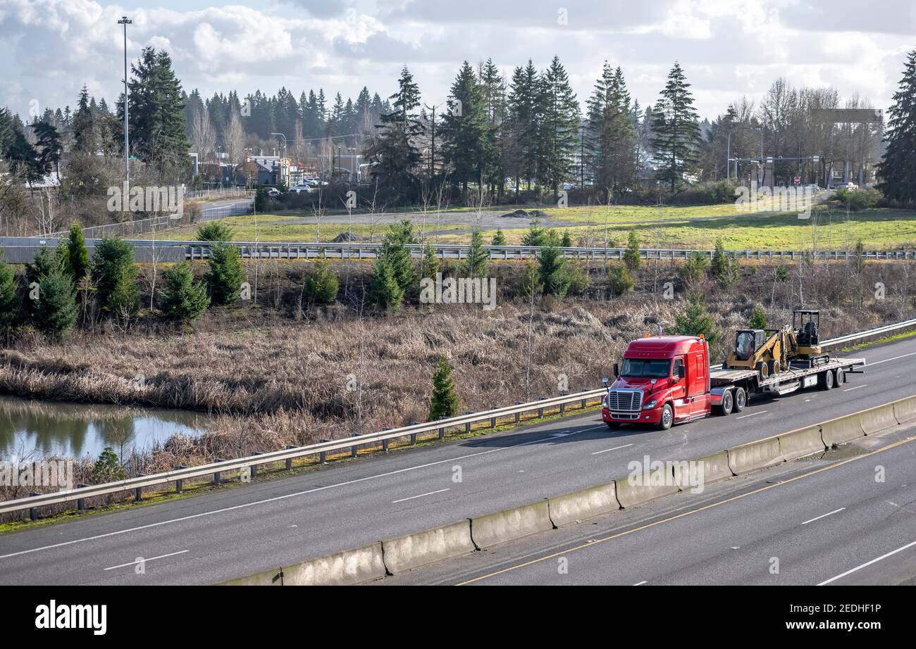 Big rig industrial red shiny semi truck tractor with low roof long cab ...