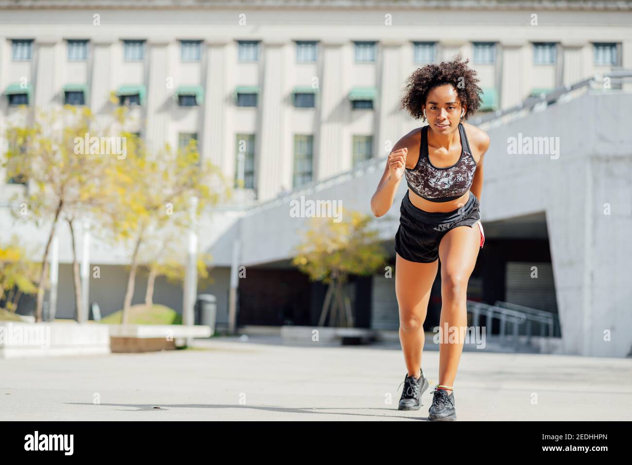 Afro athlete woman running outdoors Stock Photo - Alamy