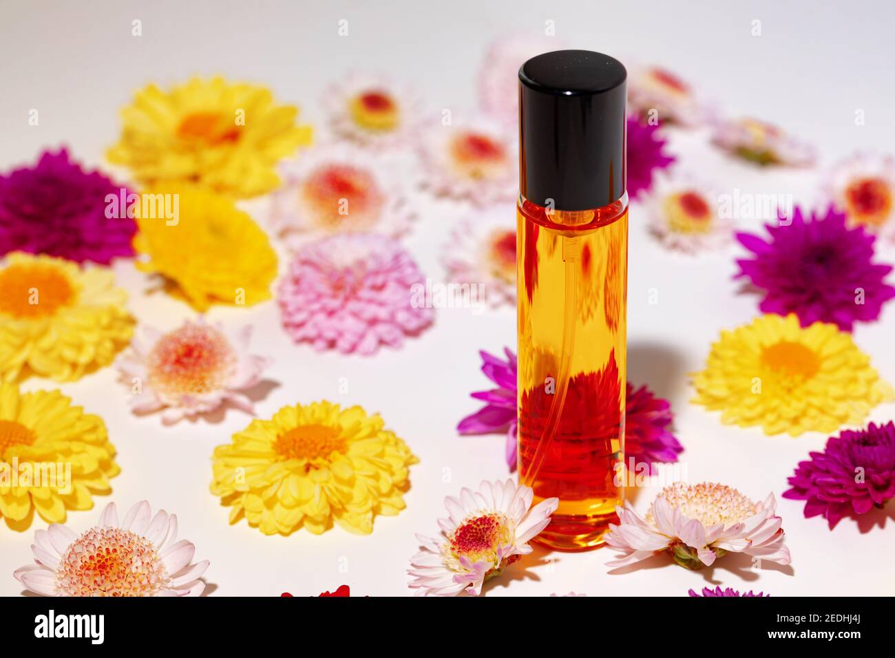 Perfume bottle for women in flower buds Stock Photo - Alamy