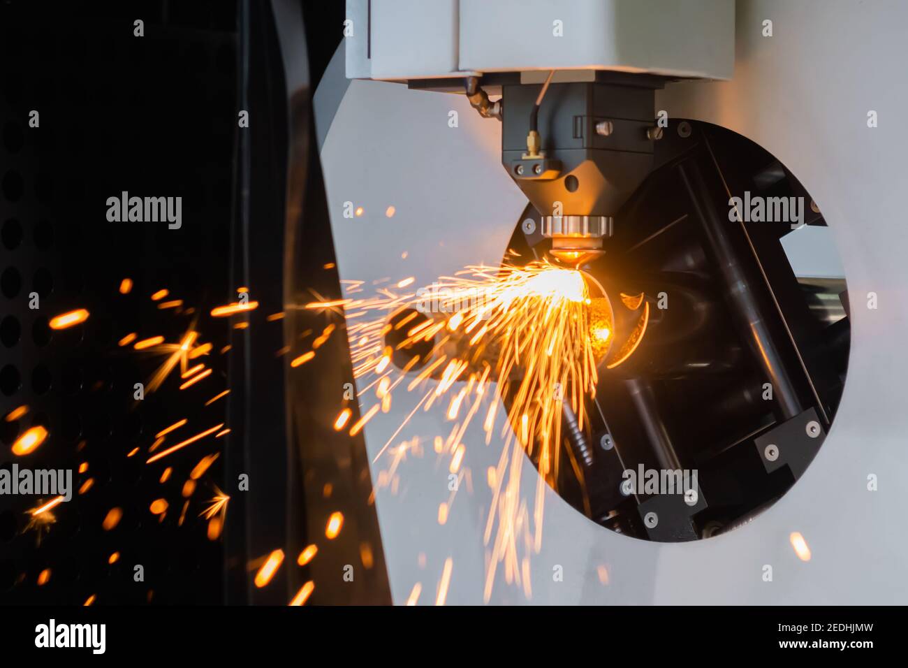 Laser cutting machine working with cylindrical metal workpiece with ...