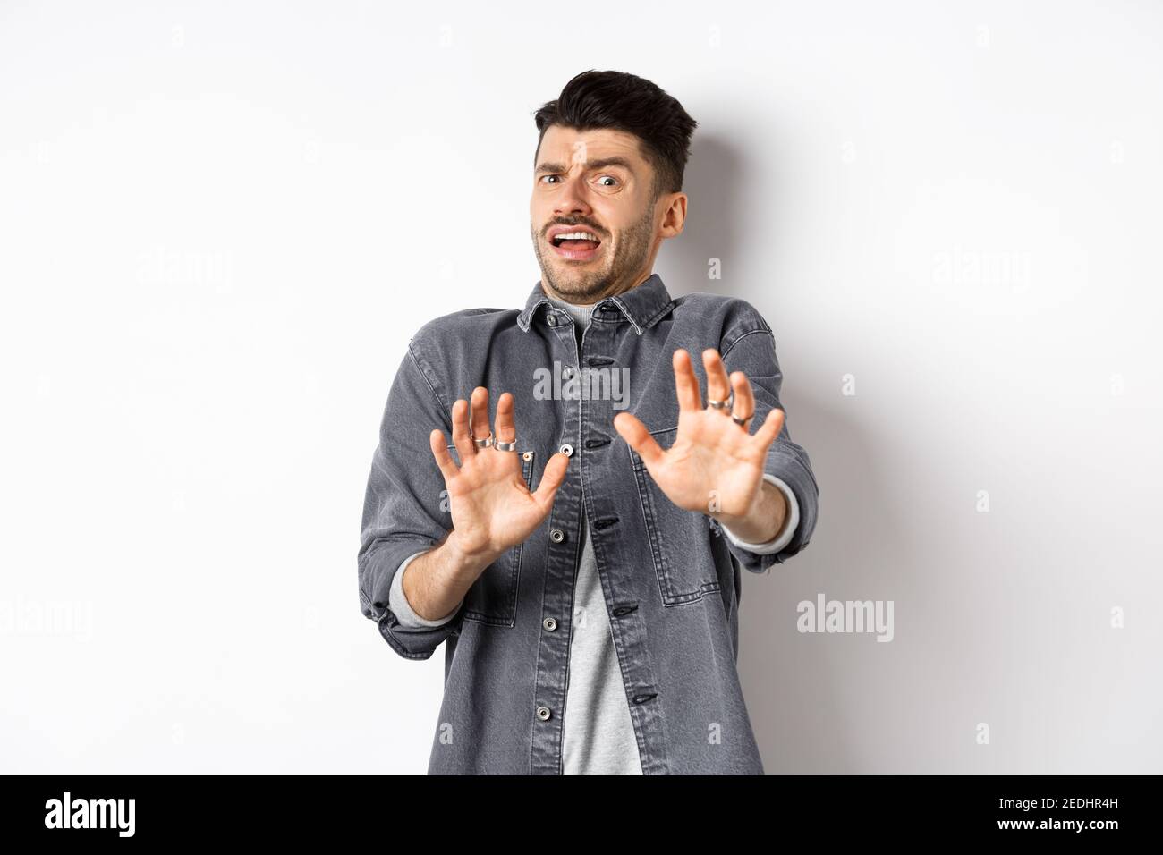 Stay away from me. Scared young man screaming and asking to stop, step ...