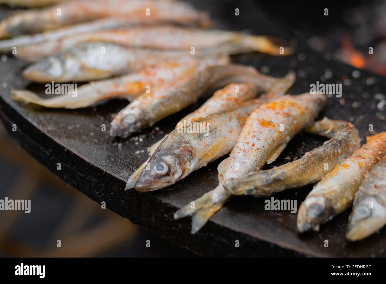 Process of cooking european smelt fish on black brazier at food ...