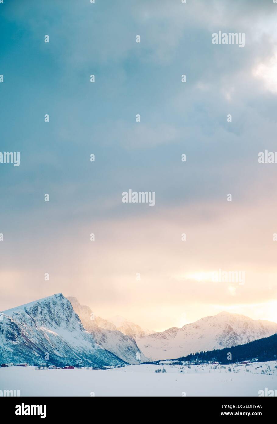 Vertical shot of mountains covered in snow under the sunset sk Stock ...