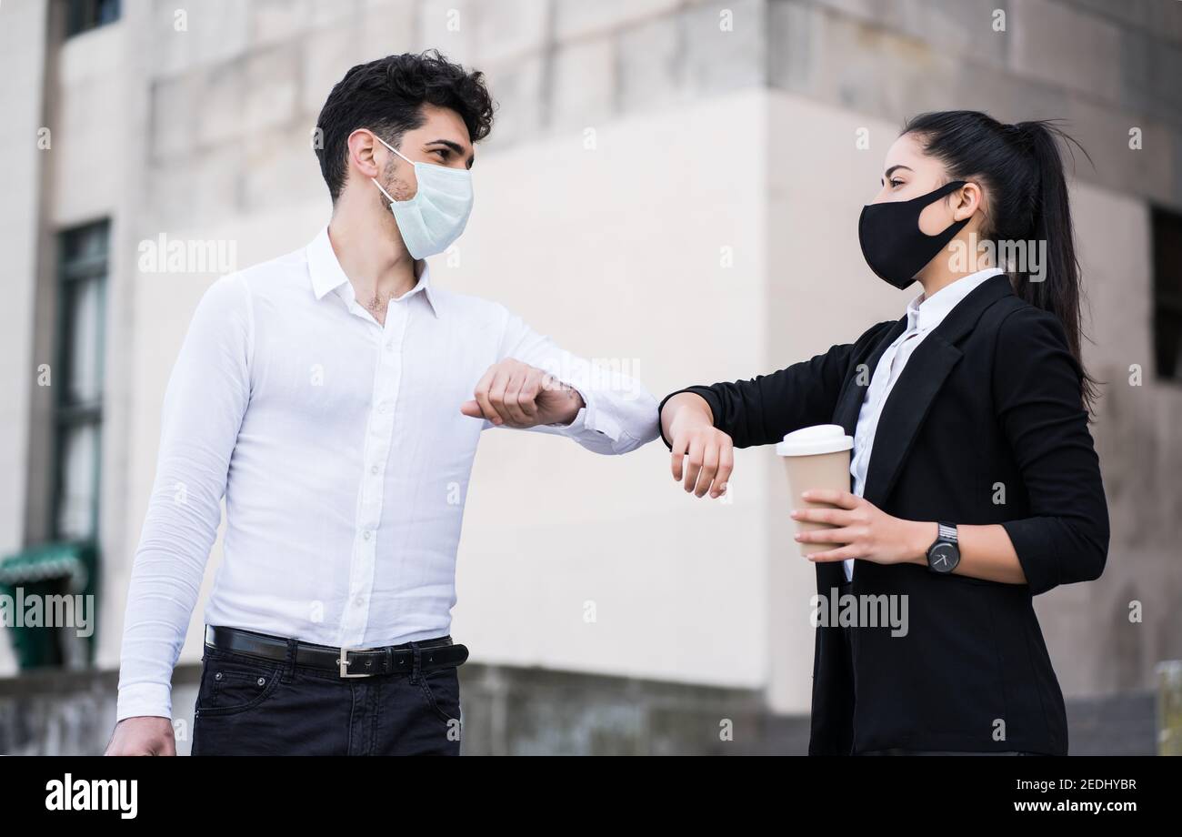 Business people bumping elbows for greeting each other Stock Photo - Alamy