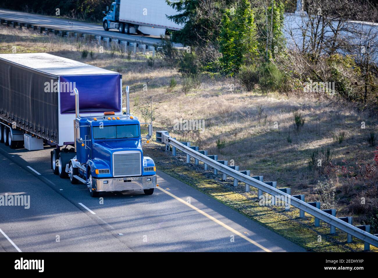 Several different big rigs semi trucks with dry van semi trailers ...
