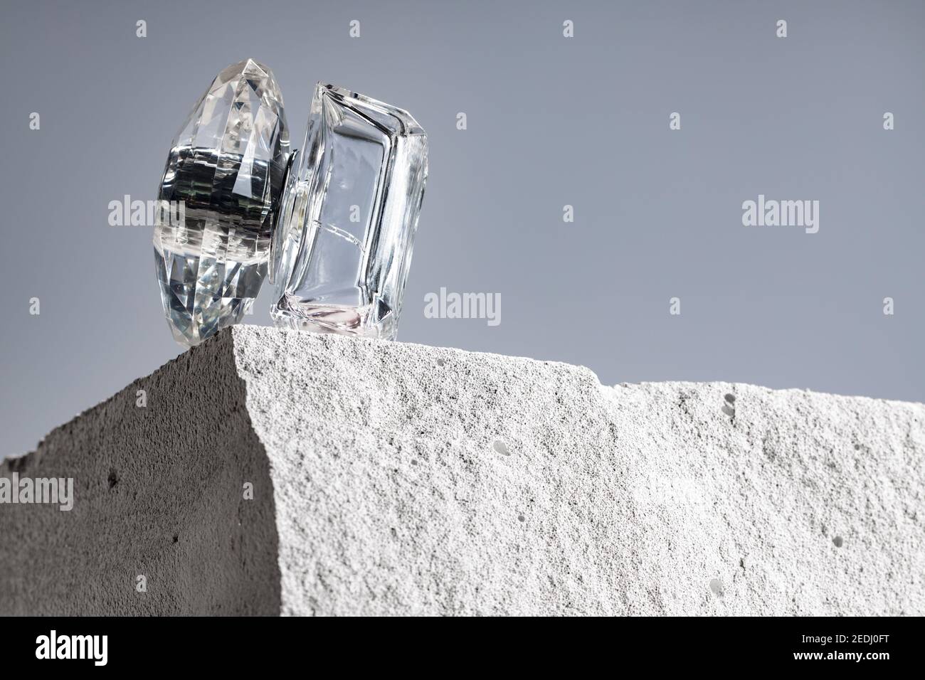 Transparent fragrance bottle on gray .cinder block Stock Photo - Alamy