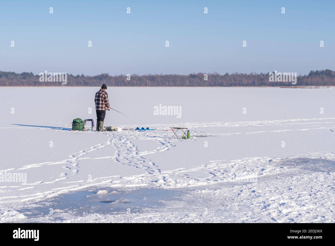An old man ice fishing Stock Photo - Alamy