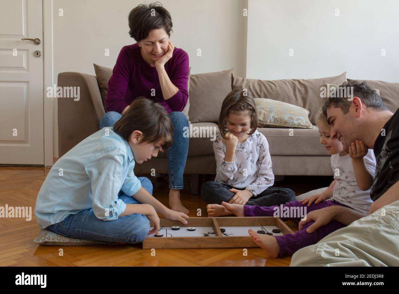 Whole Family playing game. brother and sister match. Sitting on the ...