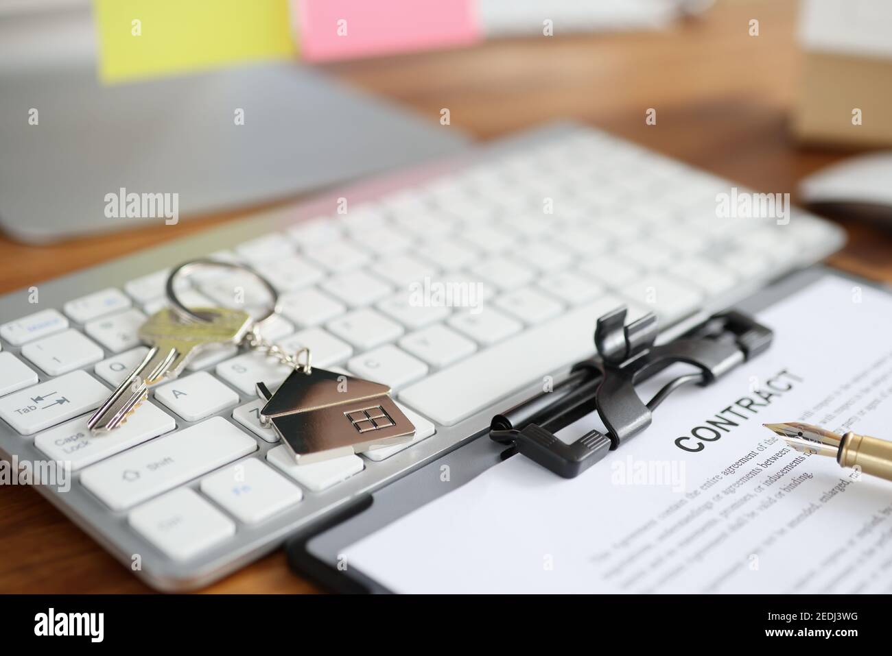 House keys and document with contract lying on keyboard closeup Stock ...