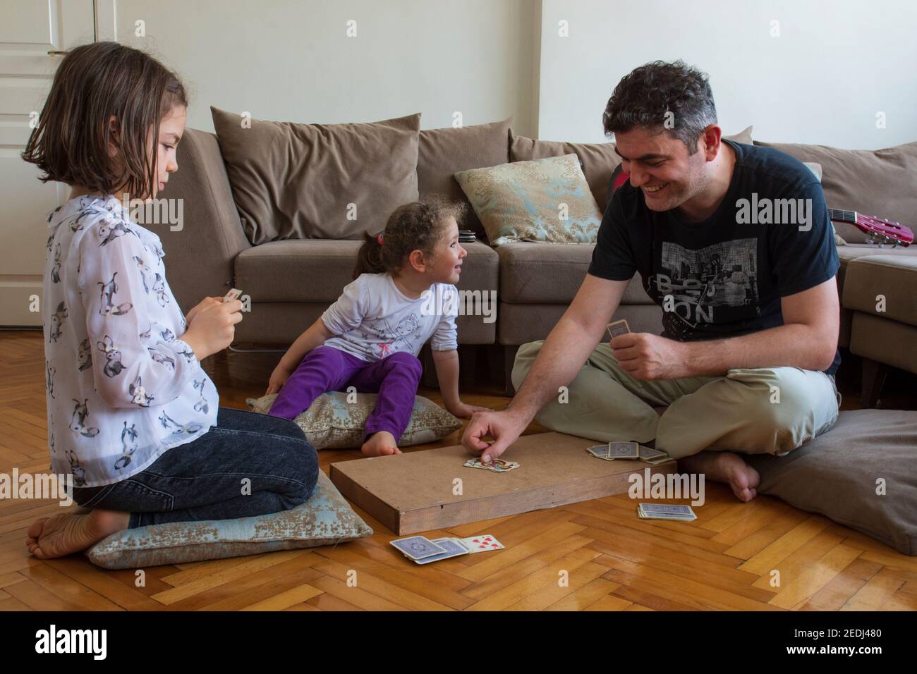 dad and kids playing and learning card gamesat home.stay at home ...
