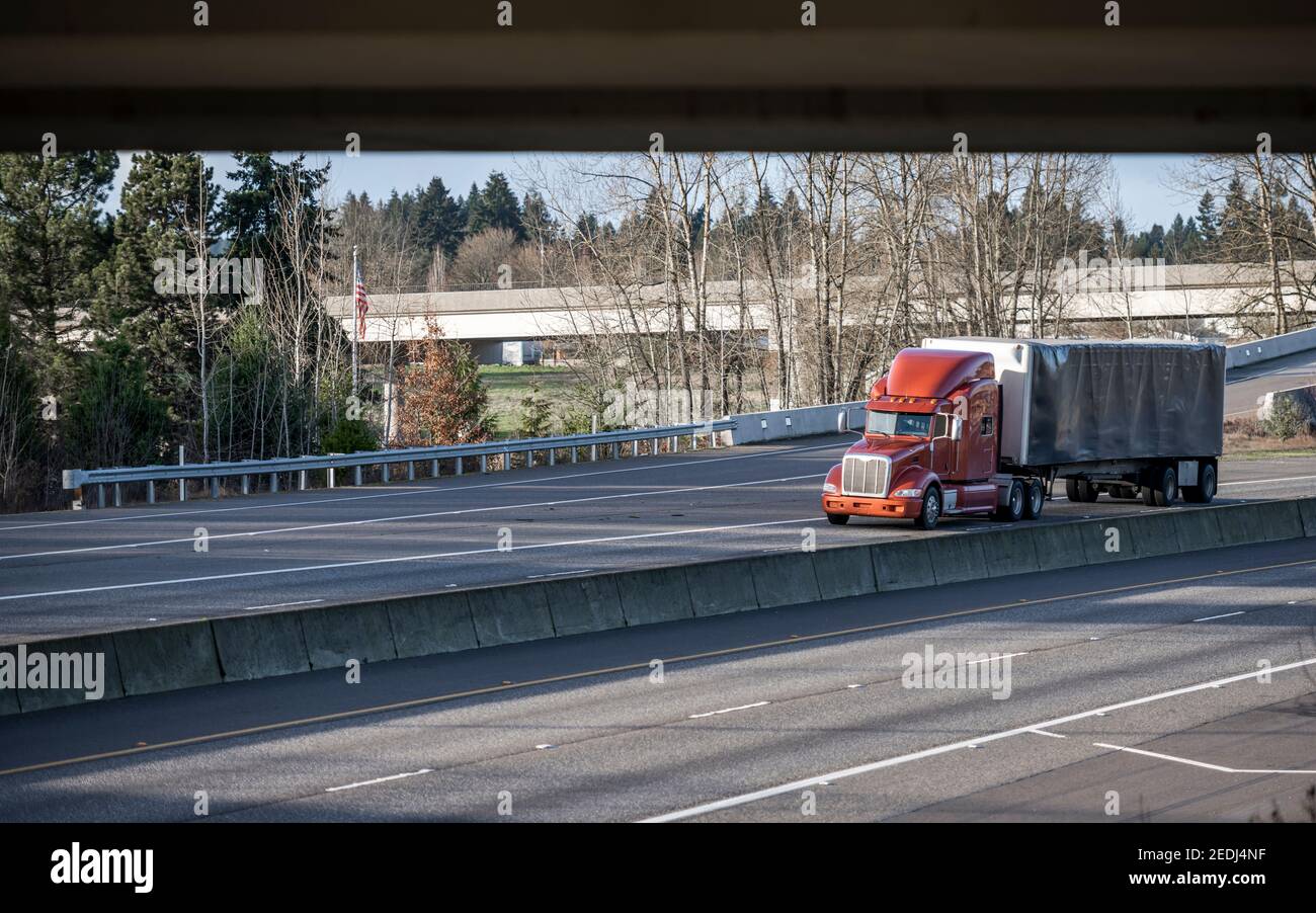 Classic powerful big rig orange semi truck tractor with sleeping ...