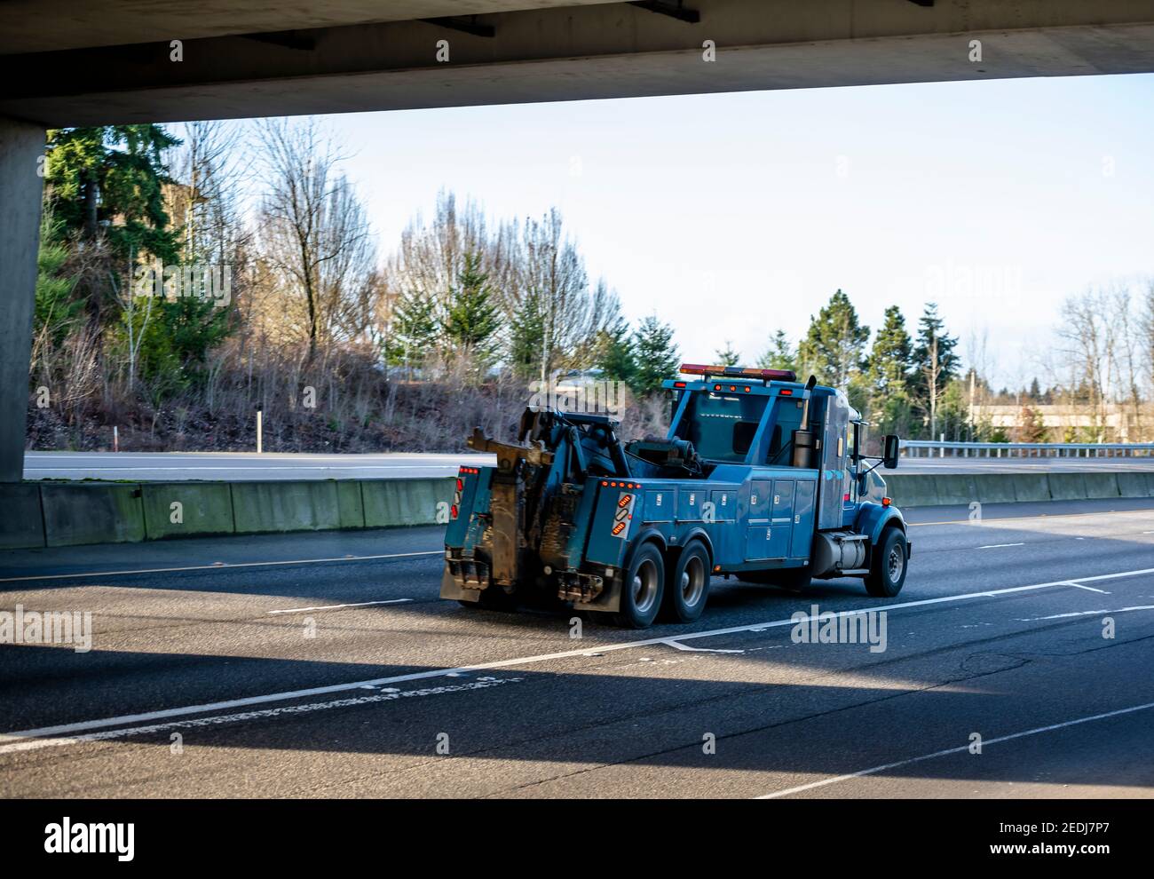 Classic big rig blue semi truck day cab tow tractor with with boom and ...