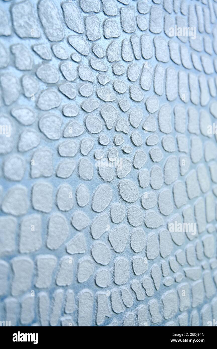 Close-up of light blue color surface similar to snake's skin ...