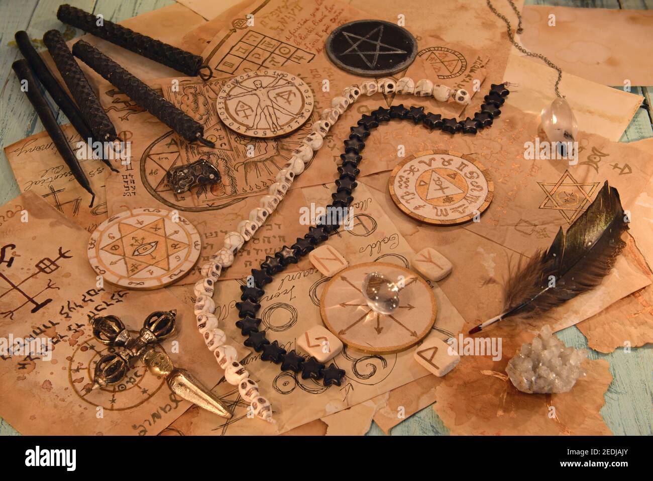 Old papers with magic spells and mystic ritual objects on witch table ...