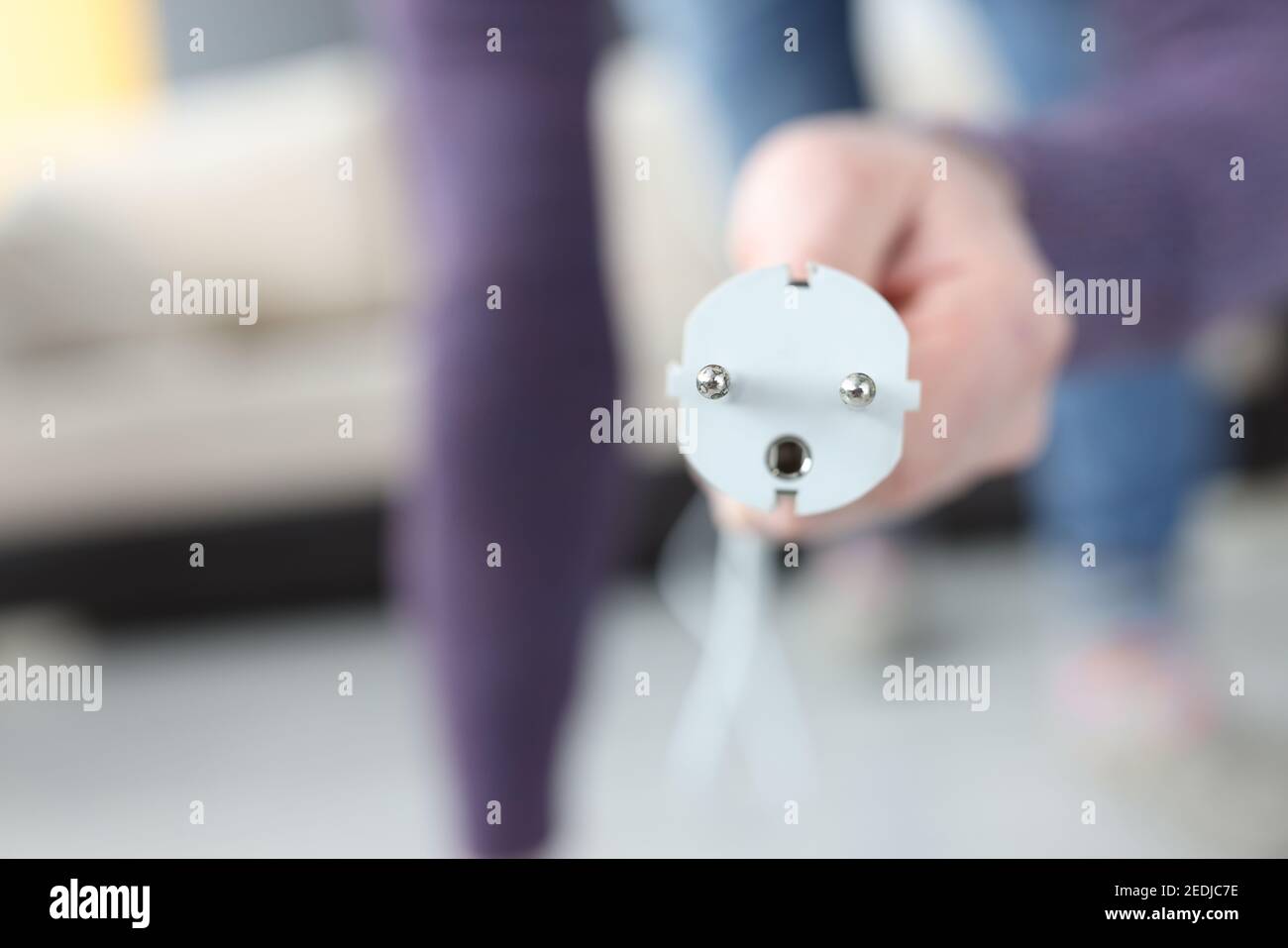 Male hand inserting plug into socket at home closeup Stock Photo - Alamy