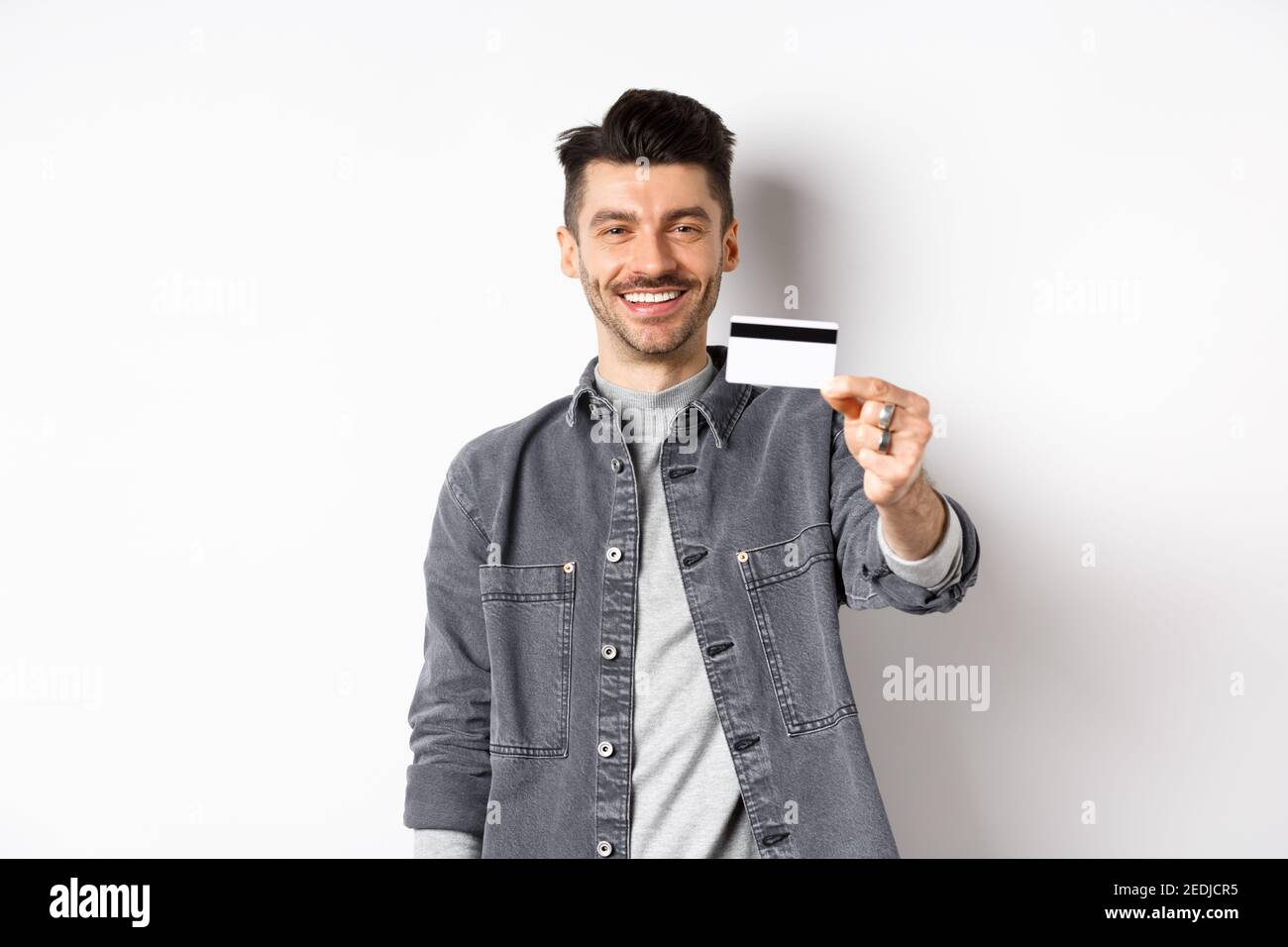 Handsome stylish guy showing plastic credit card and smiling, satisfied ...