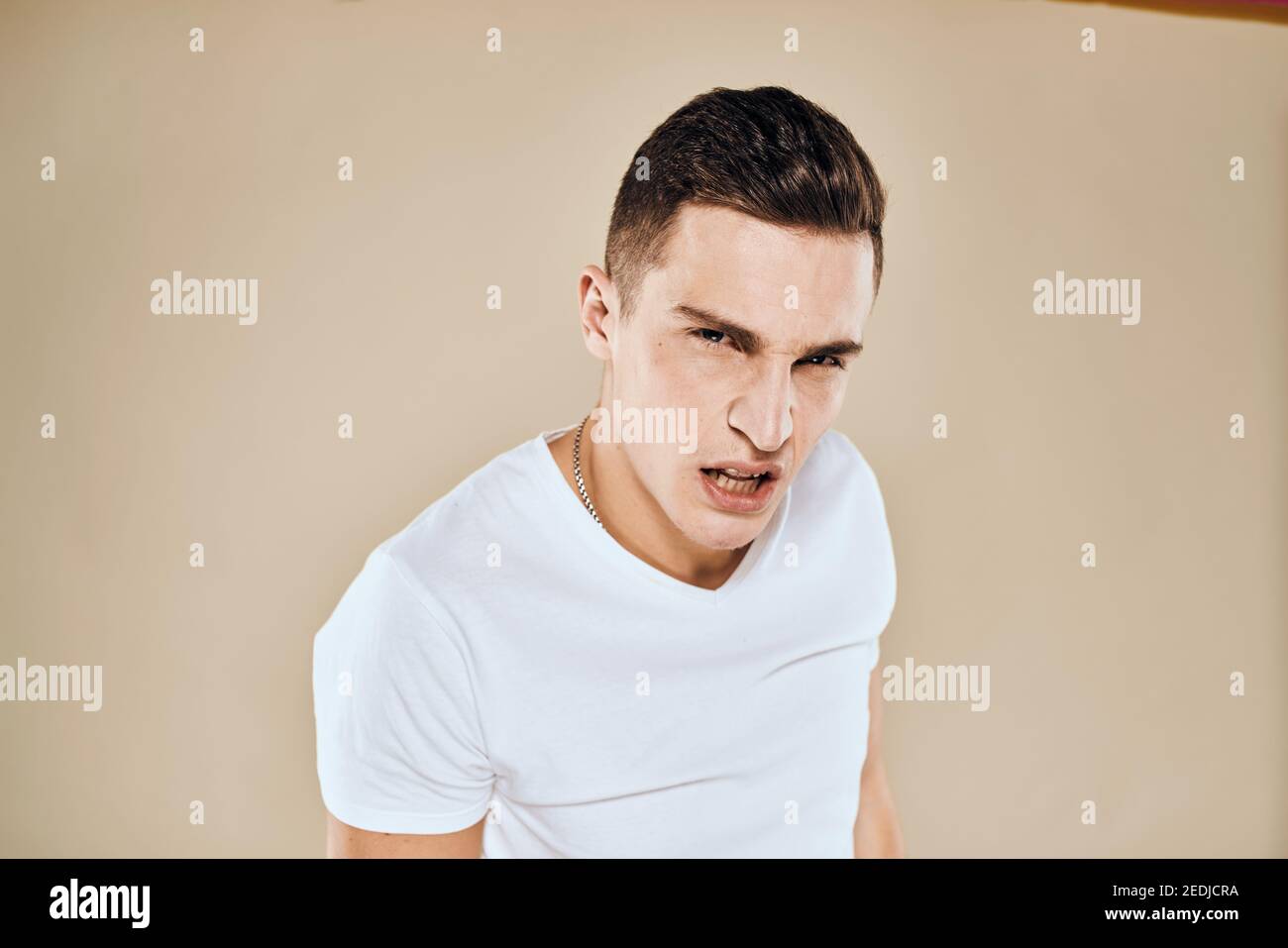 Man with displeased facial expression emotions white t-shirt gestures ...
