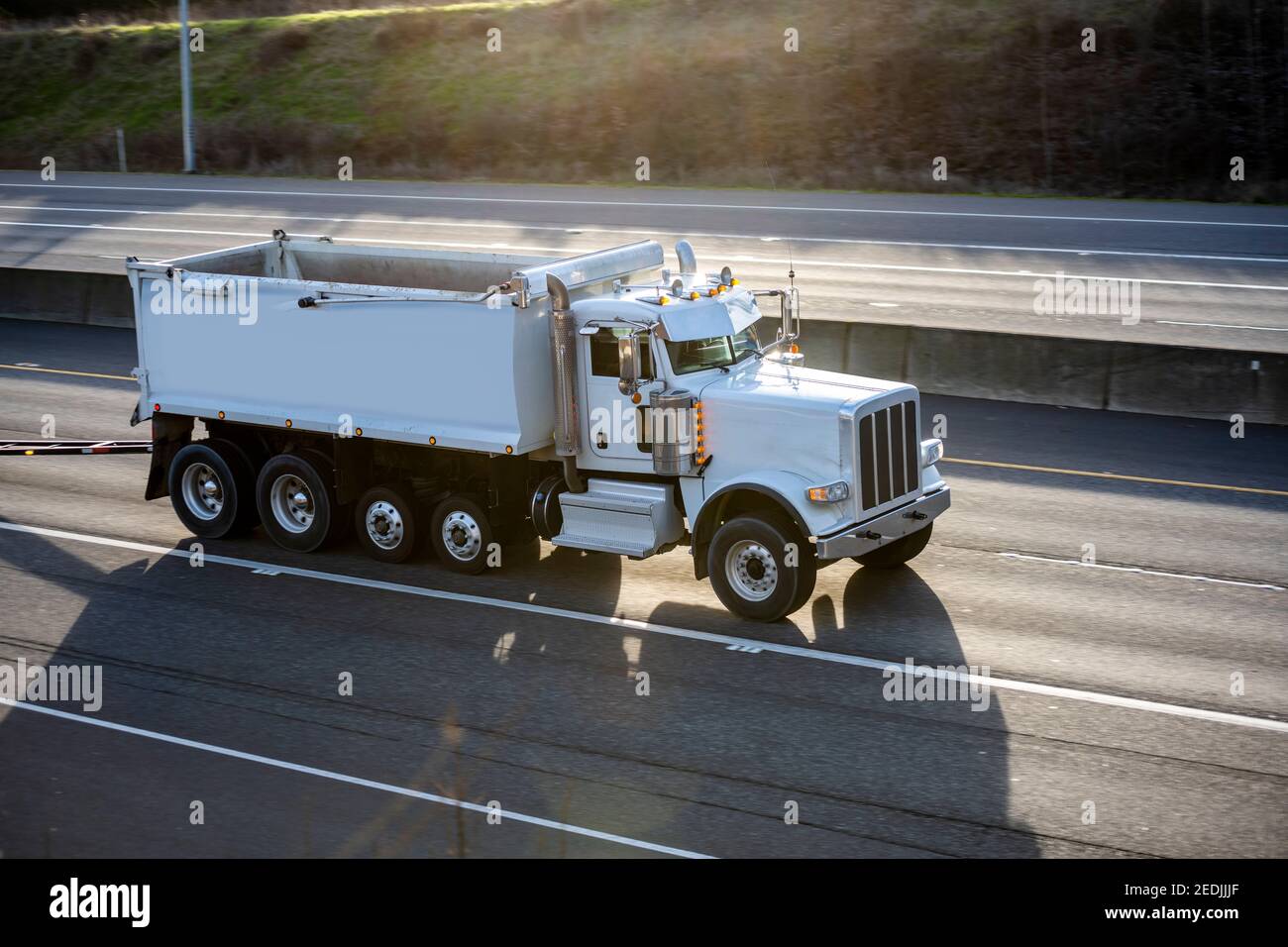 Classic big rig white semi truck day cab tractor with two tipper ...