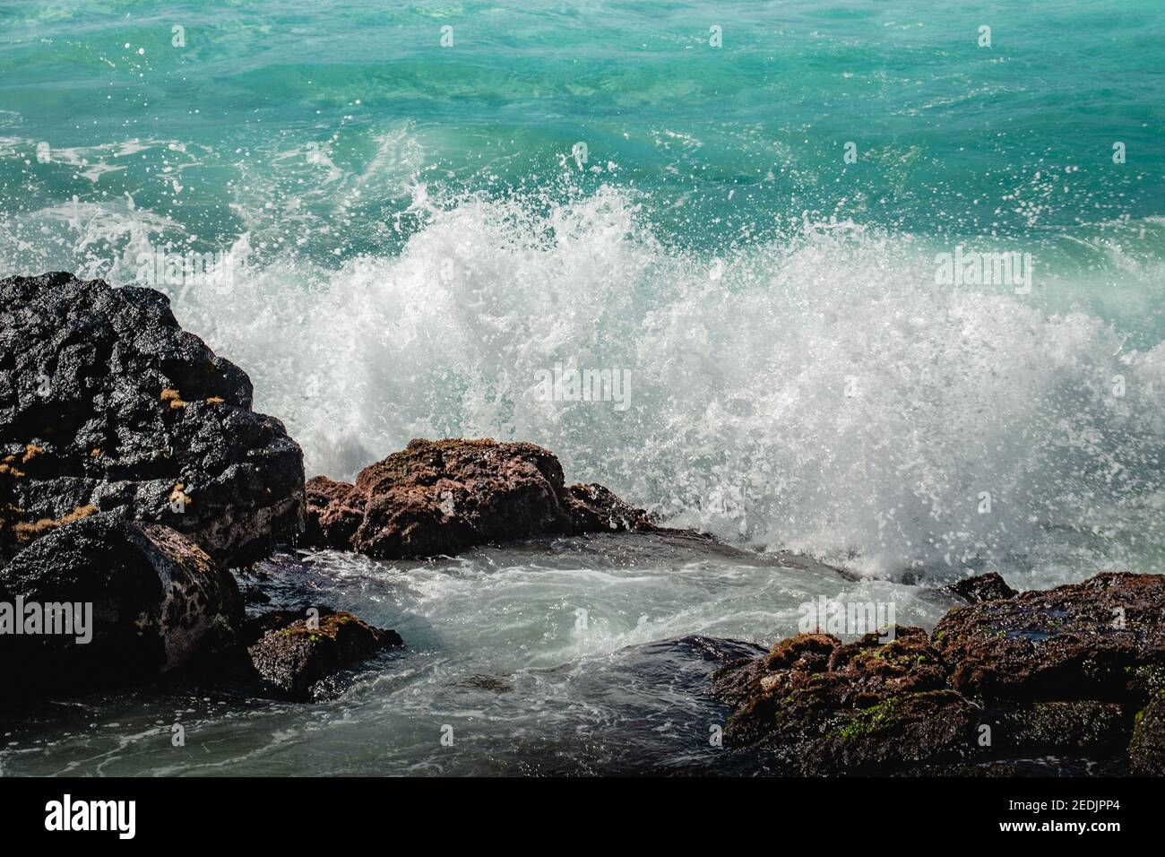 Waves crashing against rocks Stock Photo - Alamy