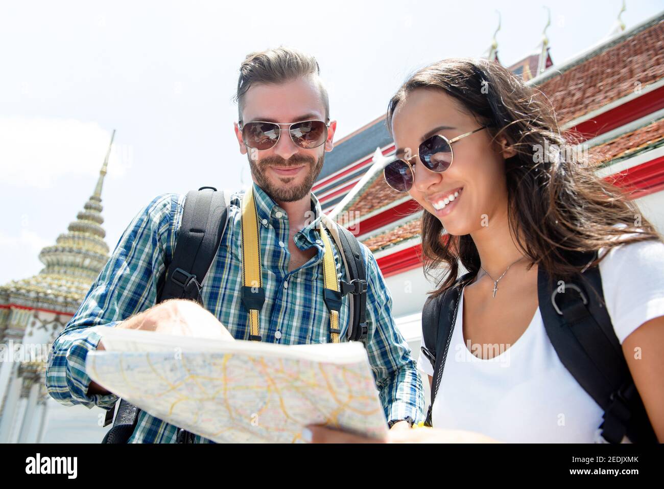 Young tourist couple backpackers traveling in Bangkok Thailand visiting ...